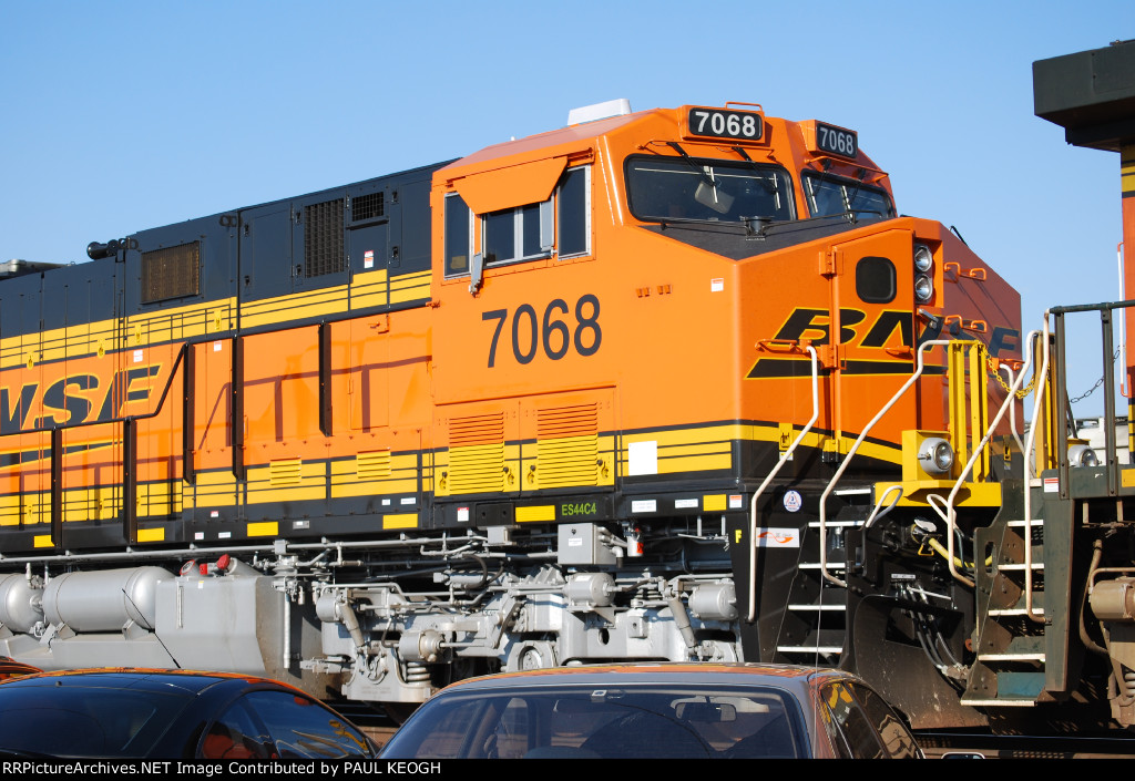 BNSF 7068 Cab shot as the Sun Glistens off Her Swoosh Logo BNSF/GE Paint Job.